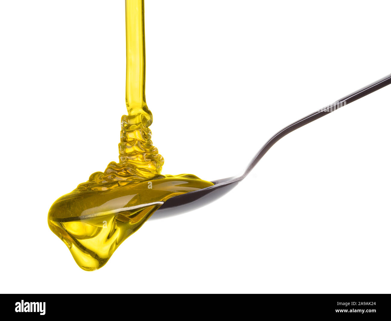 Falling and flowing honey on a spoon isolated on white with clipping ...