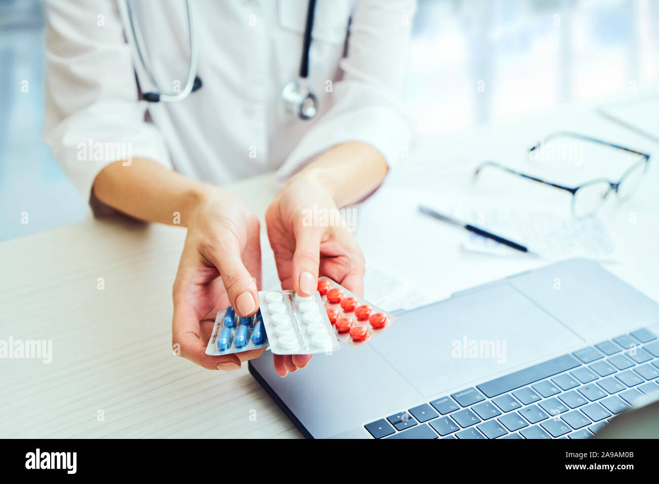 Doctor giving blue medicine pills. pharmacology concept Stock Photo - Alamy