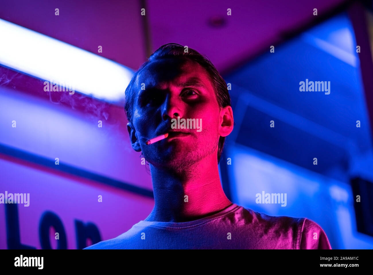 Vintage, red and blue portrait of a young man smoking a cigarette ...