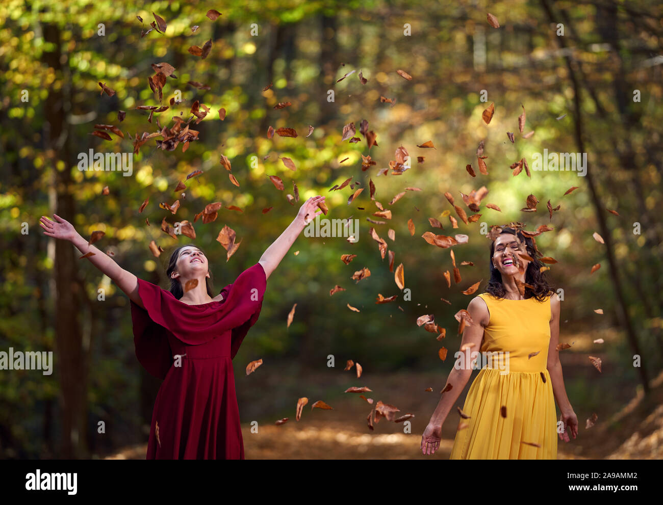Two girls throwing leaves hi-res stock photography and images - Alamy