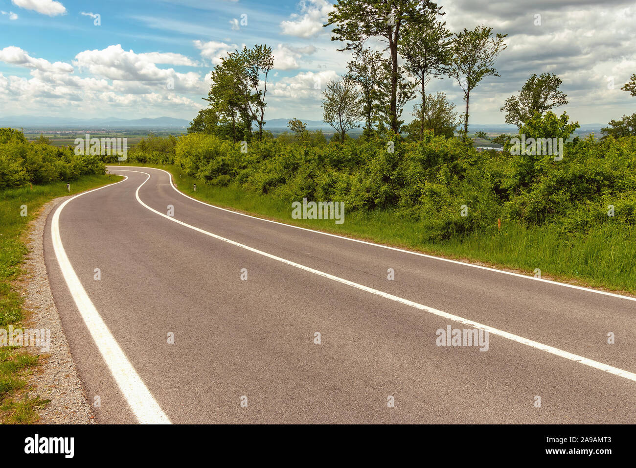 Straight asphalt road leading into the distance Stock Photo - Alamy