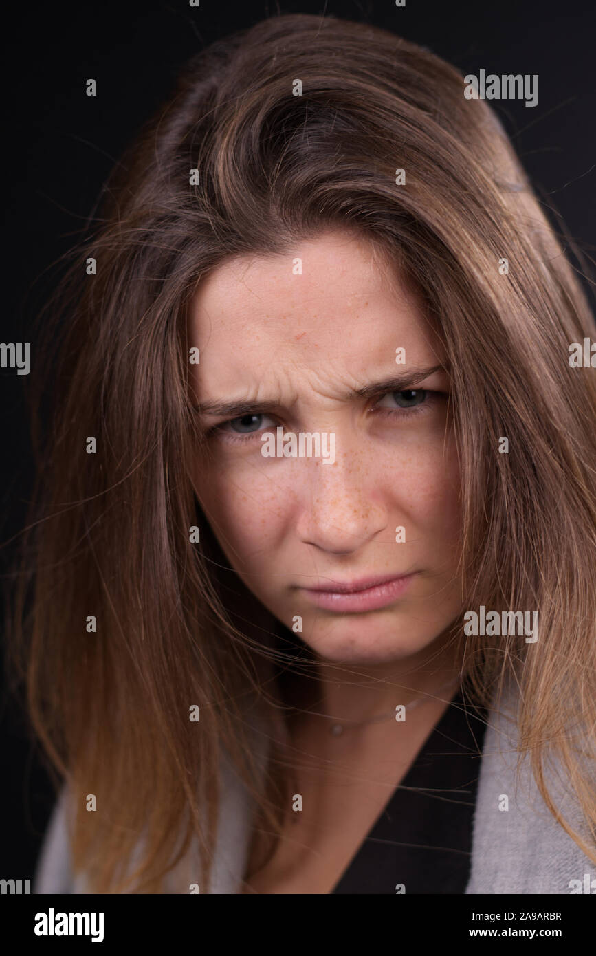 Portrait of a natural and fresh young woman with long hair. She has an ...