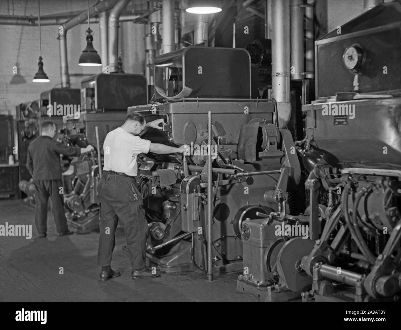Workers with their machines in a factory hall, Germany 1930s Stock ...