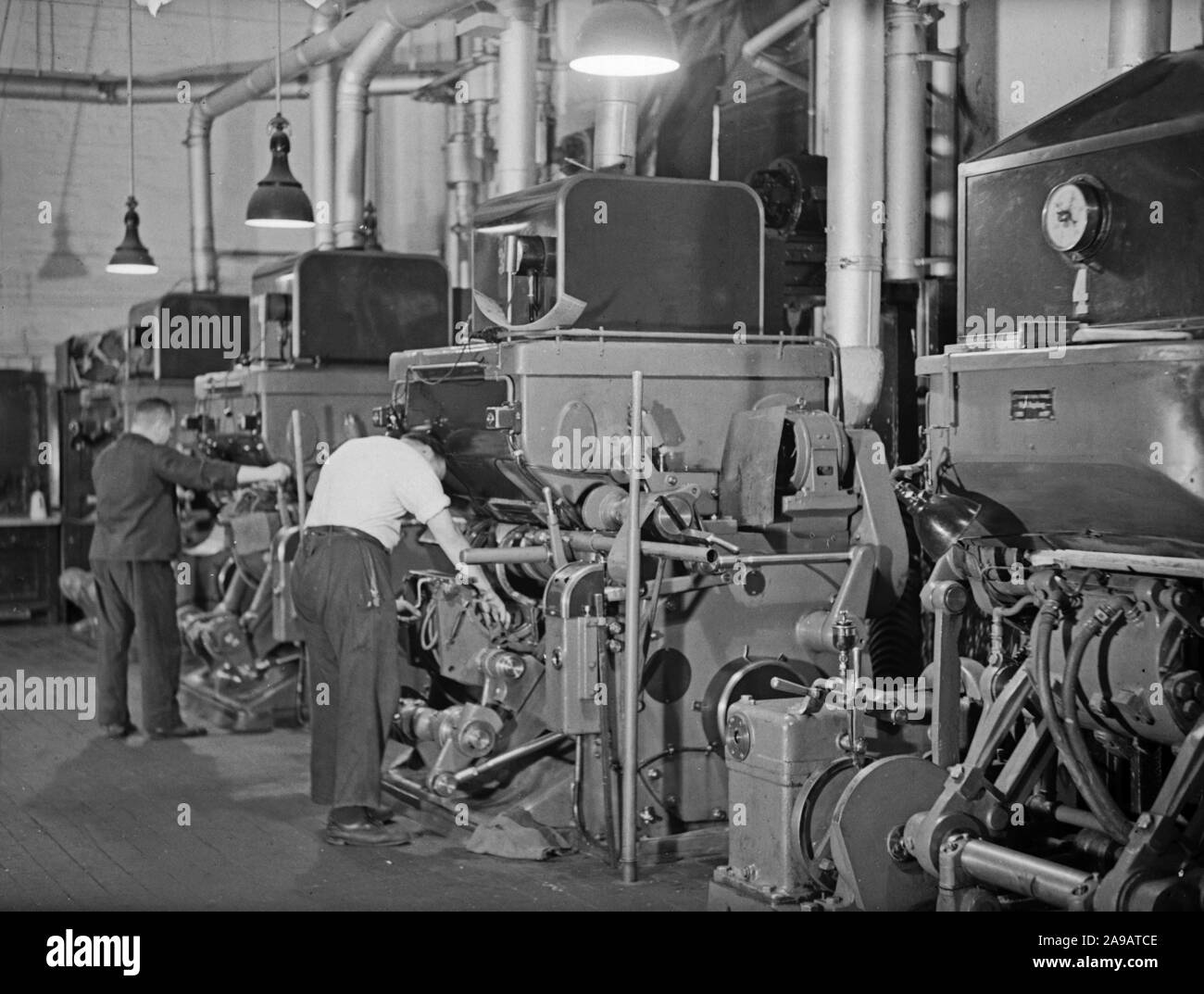 Workers with their machines in a factory hall, Germany 1930s Stock ...