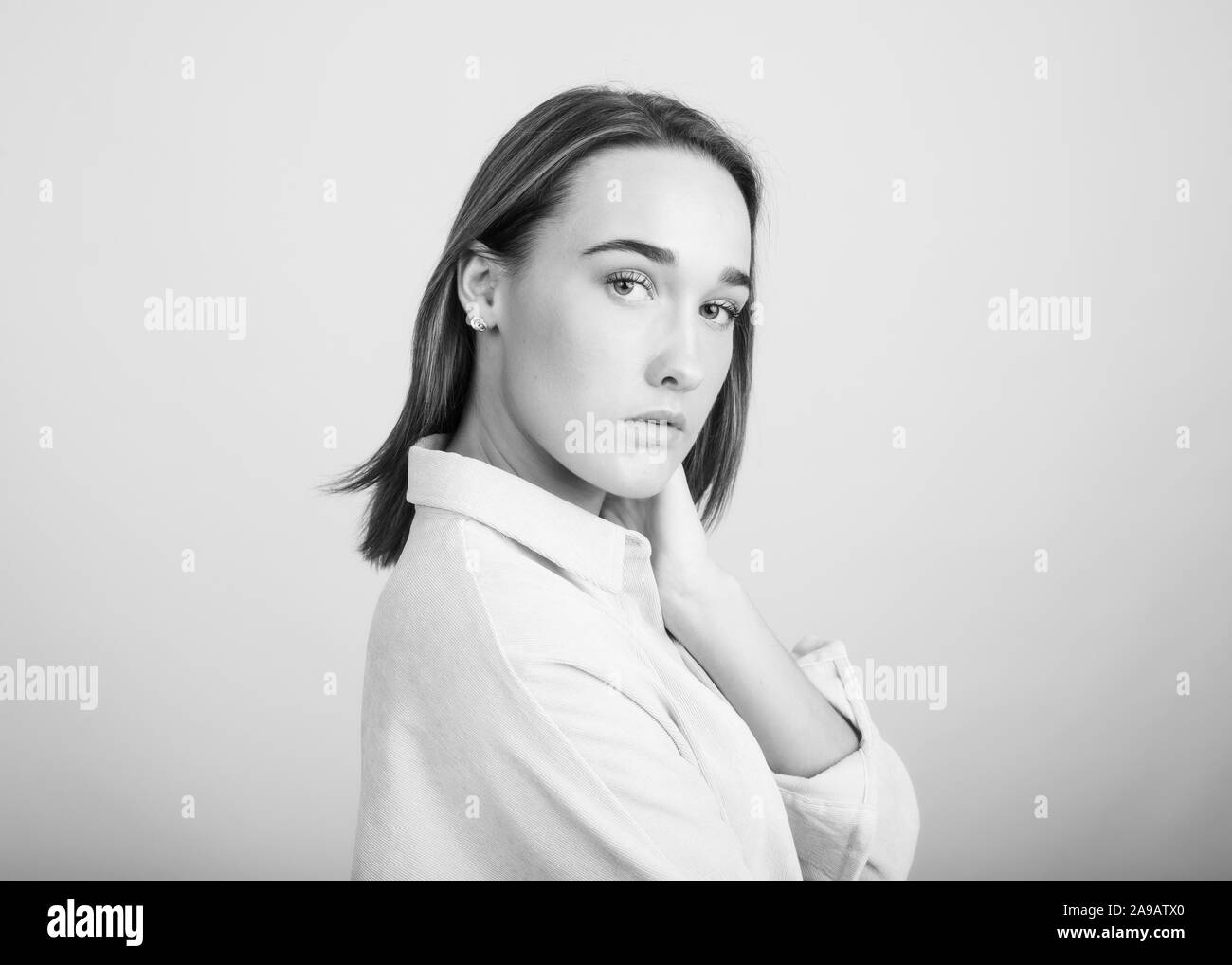 Black And White Portrait Of A Brunette Woman In Front Of Light