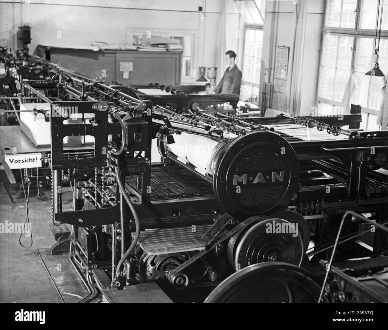 Workers on a printing machine in a printing office, Germany 1930s Stock ...