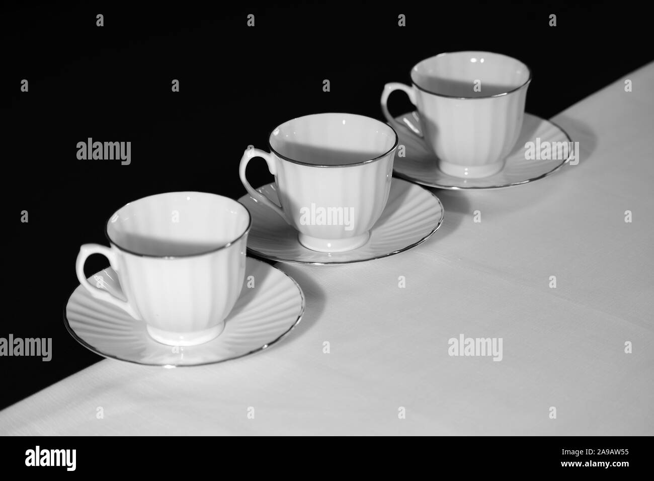 Three tea cups and saucers kept diagonally Stock Photo - Alamy