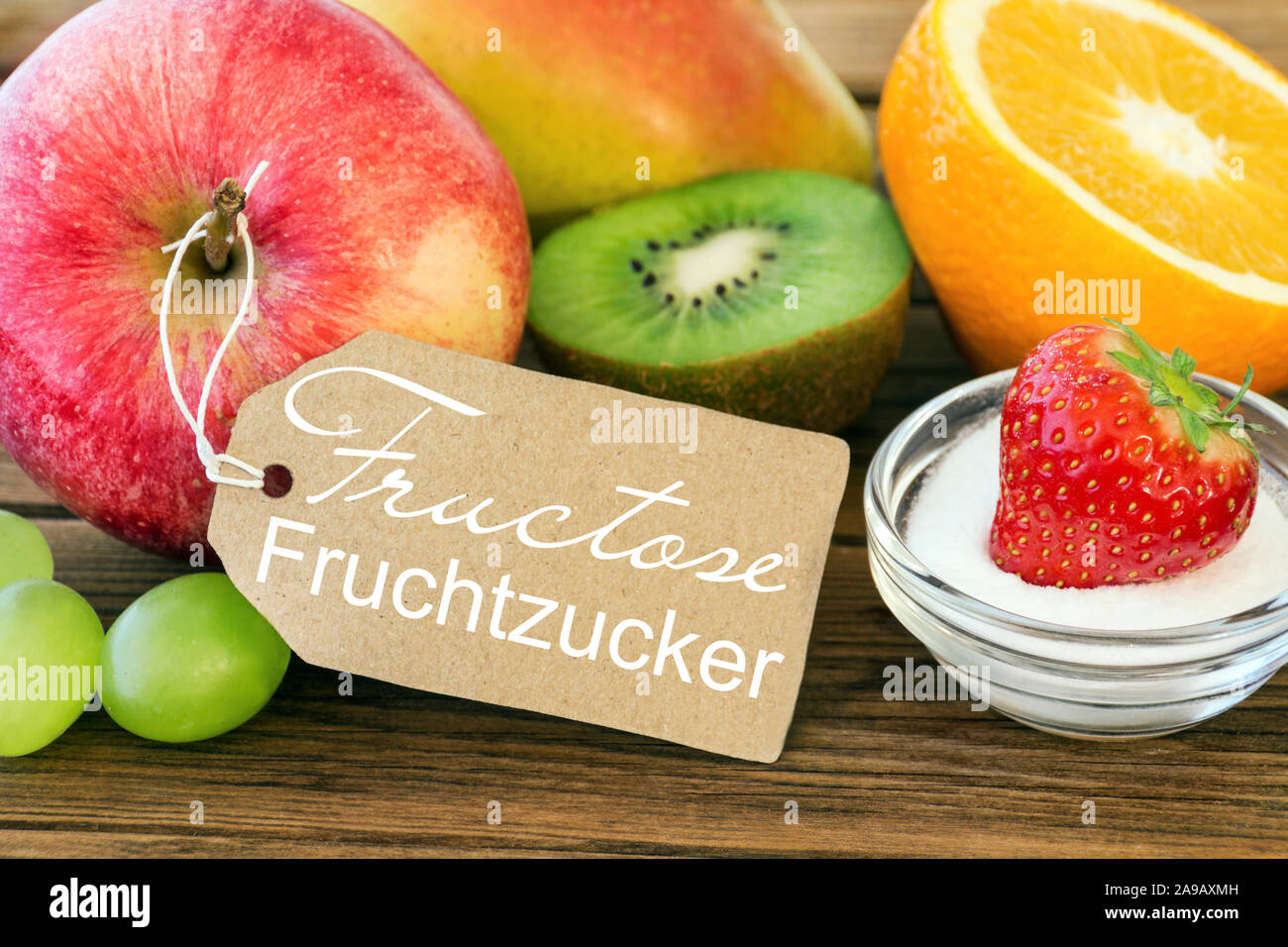 Fresh fruits with label German: Fructose Stock Photo - Alamy