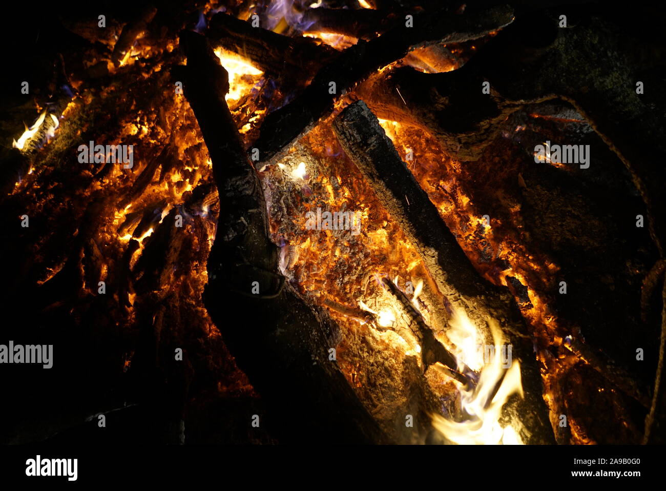 Classic camping campfire in rock fire ring at dusk closeup. Fire ...