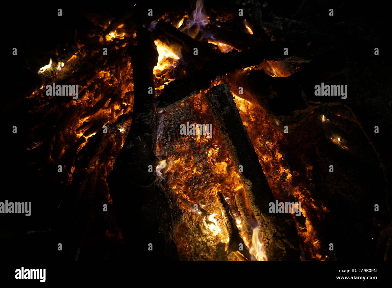 Classic camping campfire in rock fire ring at dusk closeup. Fire ...