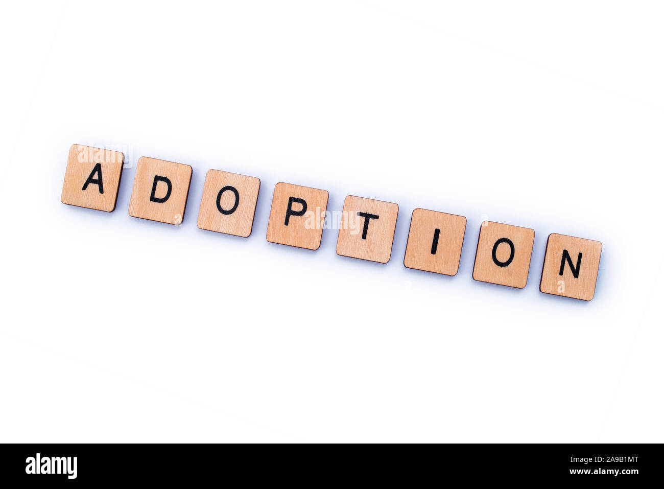 The word ADOPTION, spelt out with wooden letter tiles Stock Photo - Alamy