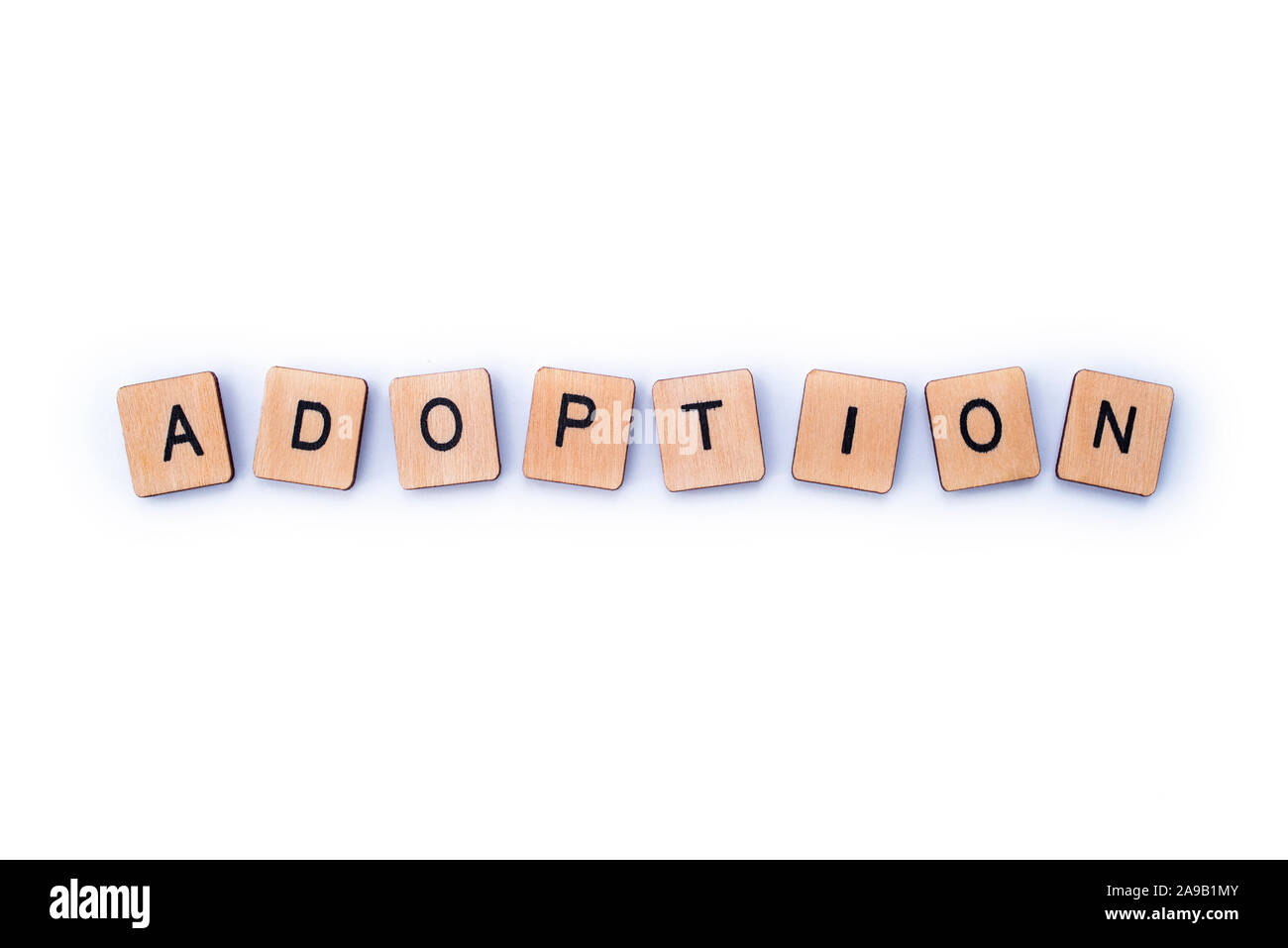 The word ADOPTION, spelt out with wooden letter tiles Stock Photo - Alamy