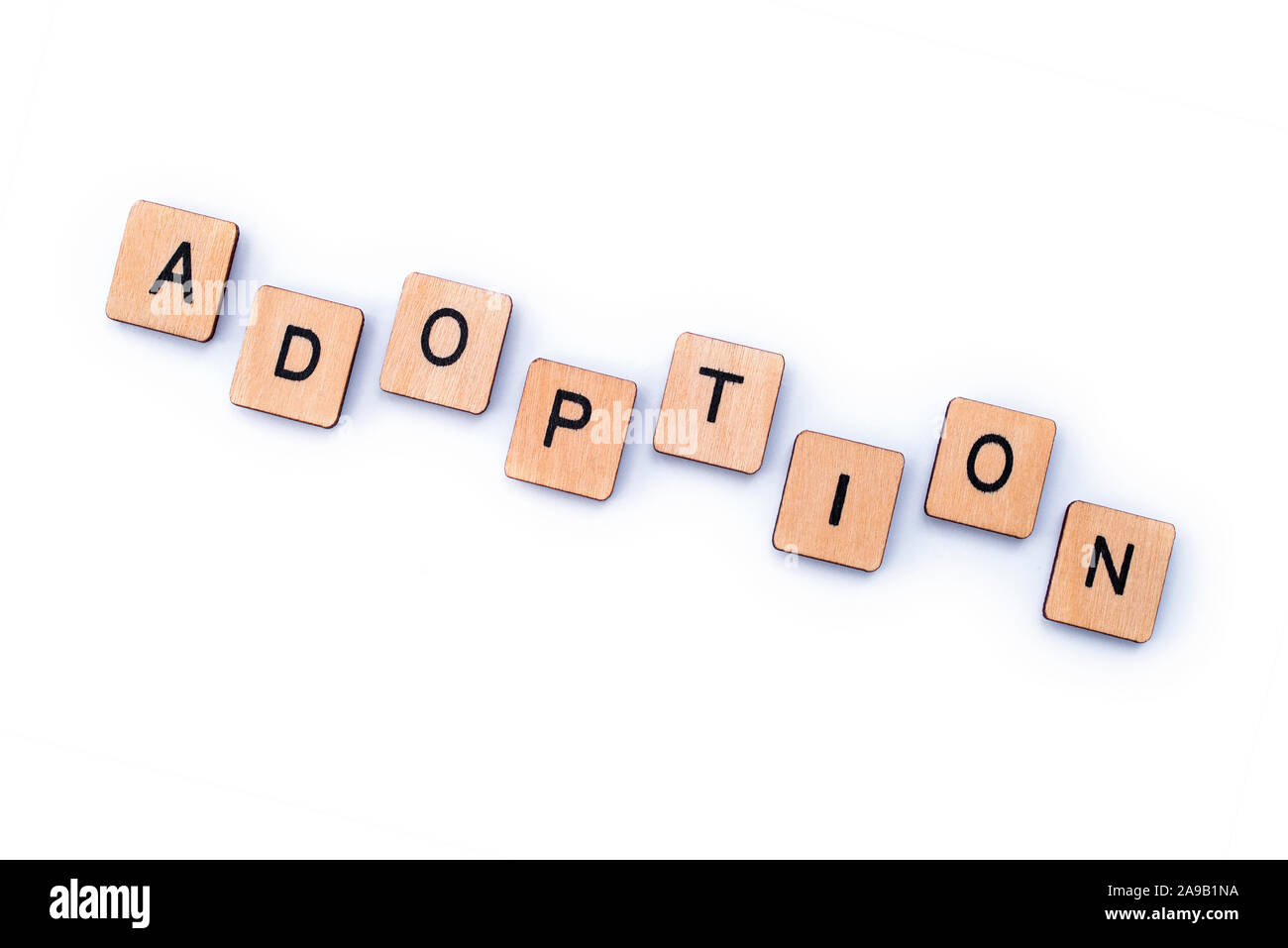 The word ADOPTION, spelt out with wooden letter tiles Stock Photo - Alamy