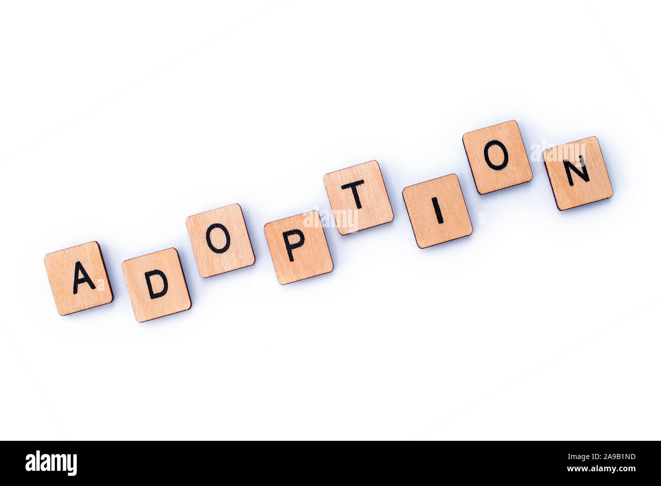 The word ADOPTION, spelt out with wooden letter tiles Stock Photo - Alamy