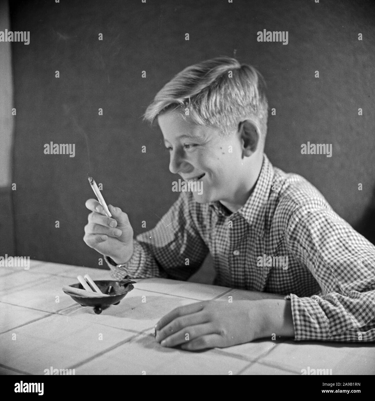 A curious boy trying his first cigarette, Germany 1940s Stock Photo - Alamy