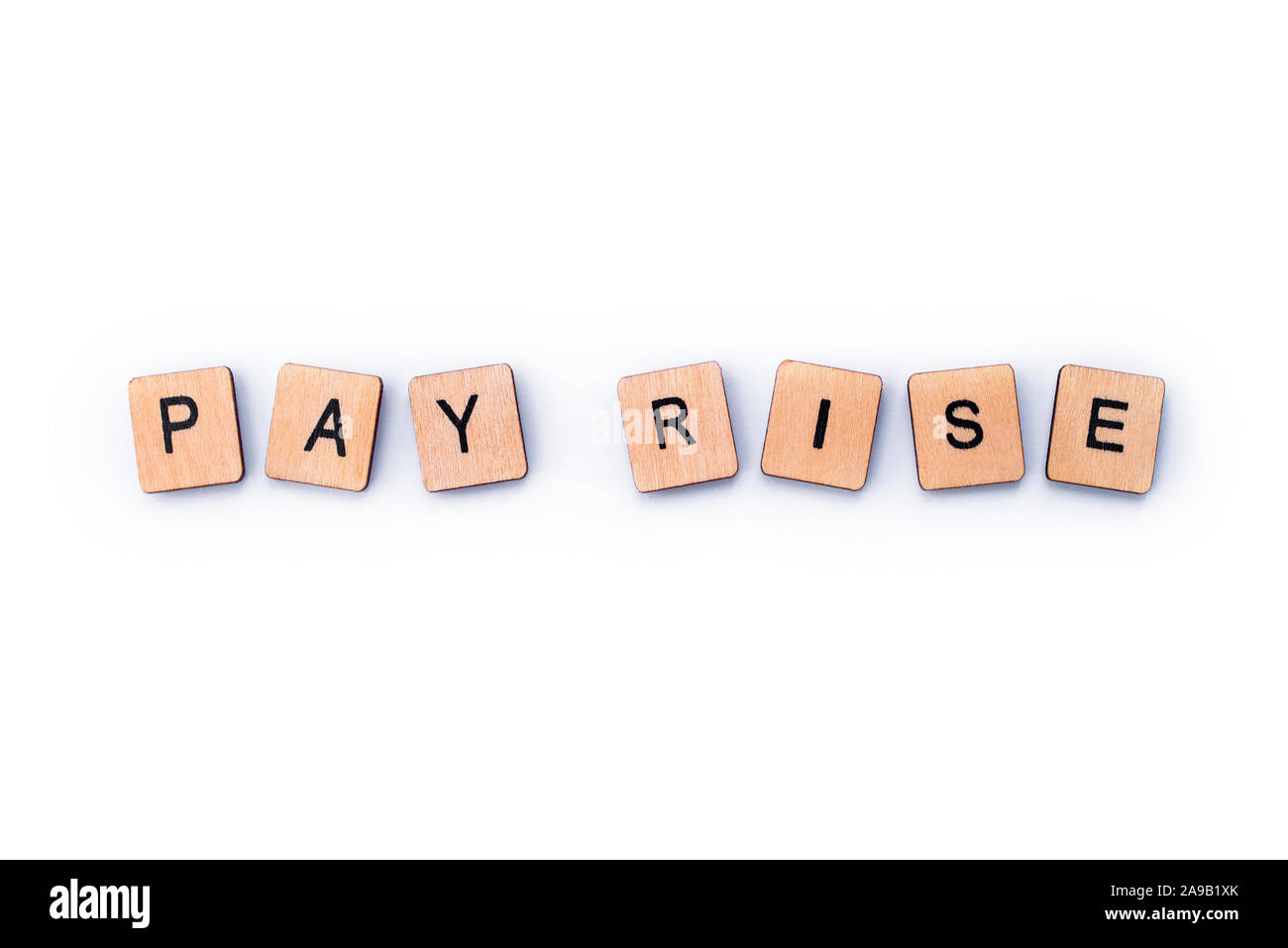 PAY RISE, spelt out with wooden letter tiles Stock Photo - Alamy