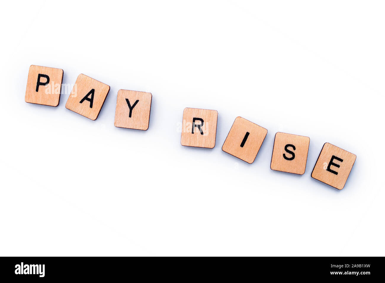 PAY RISE, spelt out with wooden letter tiles Stock Photo - Alamy