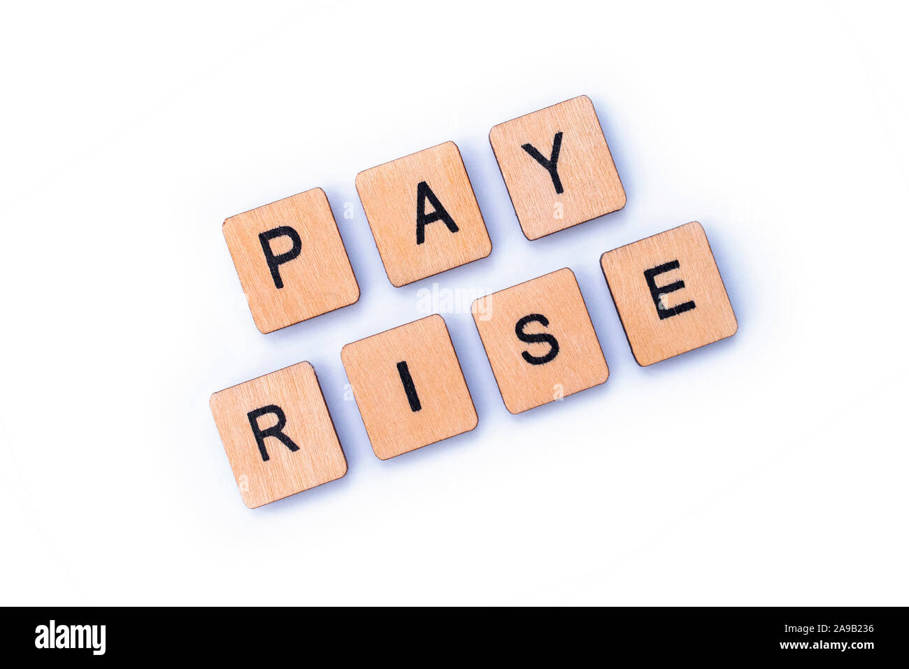 PAY RISE, spelt out with wooden letter tiles Stock Photo - Alamy