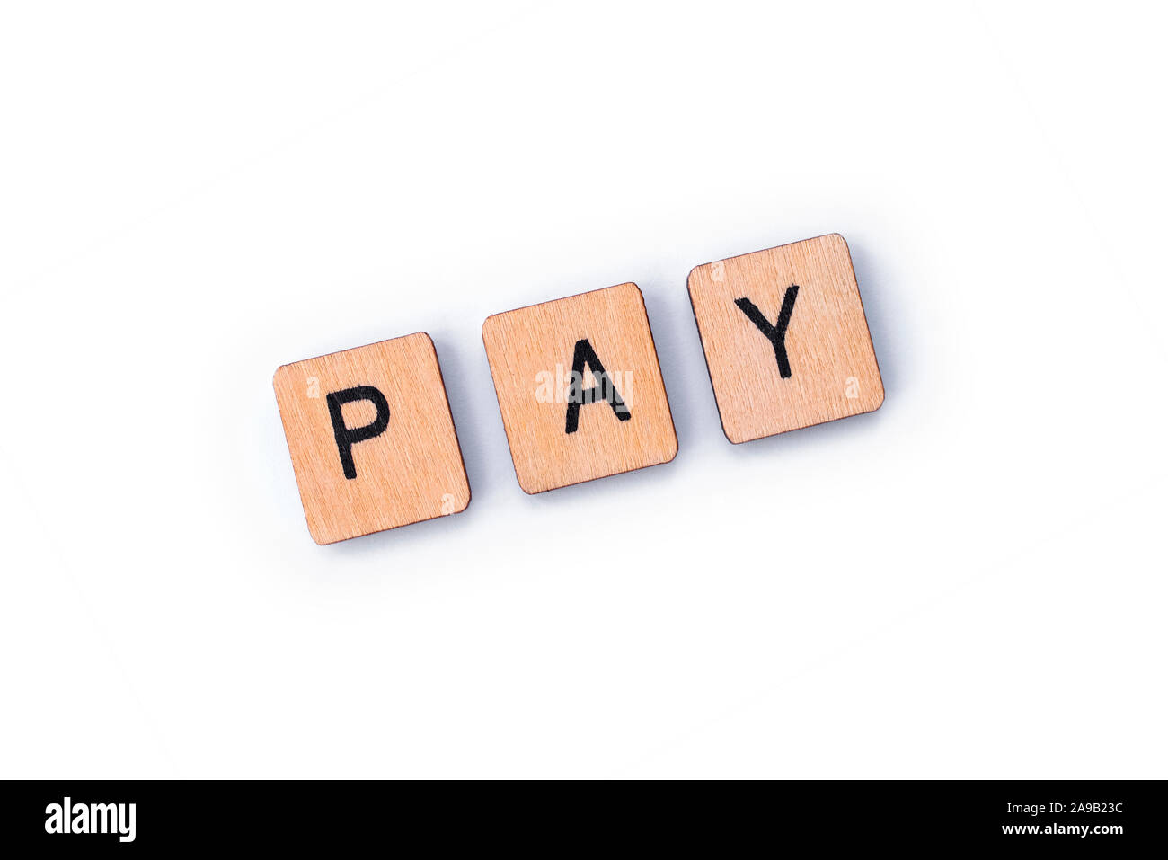 The word PAY, spelt out with wooden letter tiles Stock Photo - Alamy