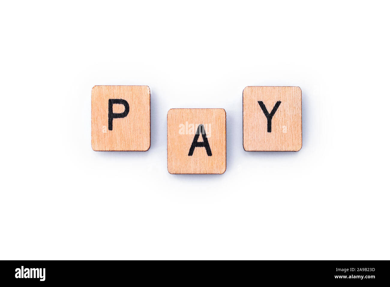 The word PAY, spelt out with wooden letter tiles Stock Photo - Alamy