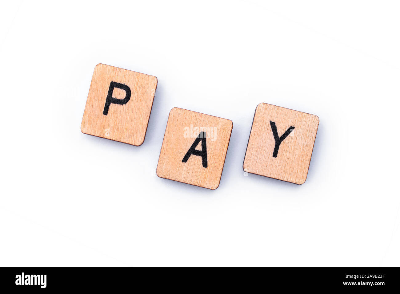 The word PAY, spelt out with wooden letter tiles Stock Photo - Alamy