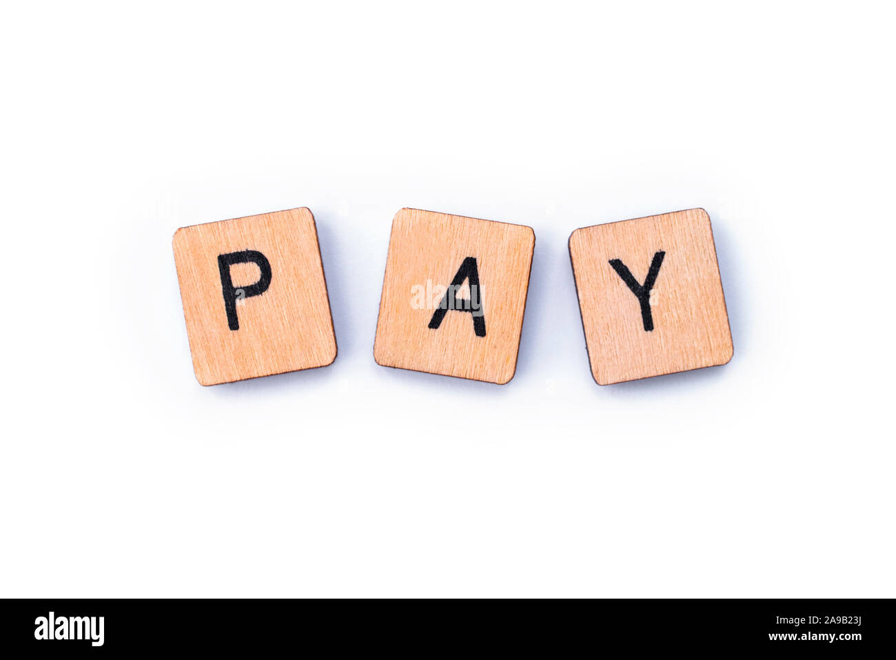 The word PAY, spelt out with wooden letter tiles Stock Photo - Alamy