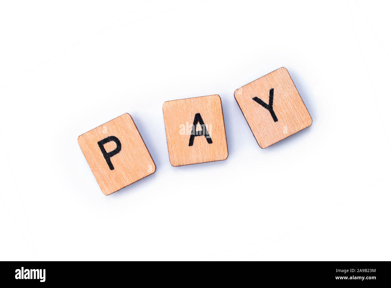 The word PAY, spelt out with wooden letter tiles Stock Photo - Alamy