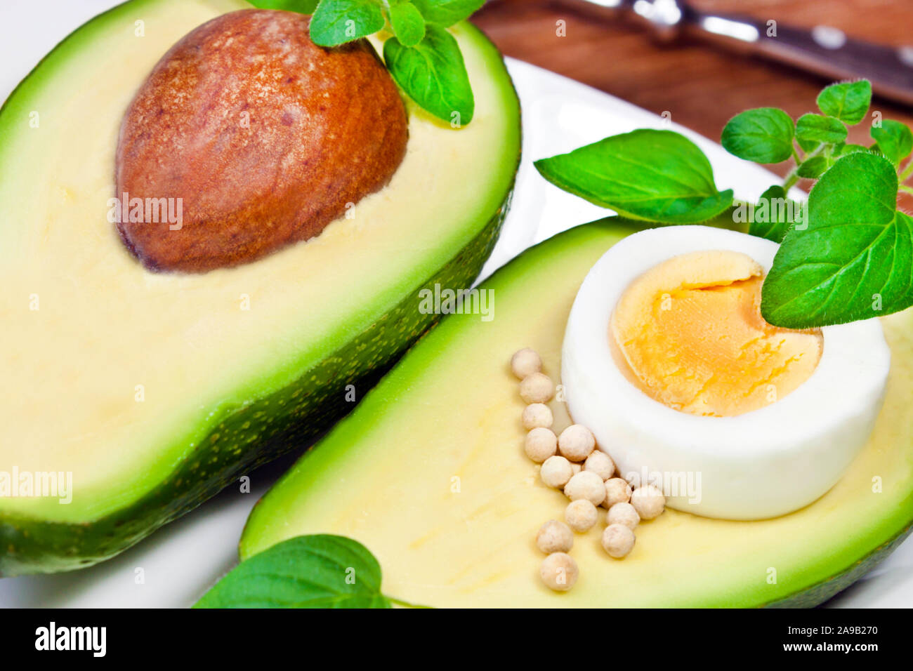Halved avocado with egg Stock Photo - Alamy