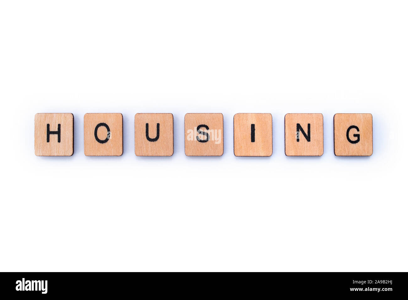 The word HOUSING, spelt with wooden letter tiles Stock Photo - Alamy