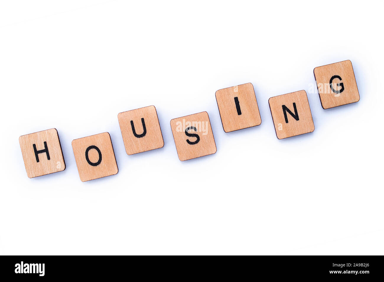 The word HOUSING, spelt with wooden letter tiles Stock Photo - Alamy