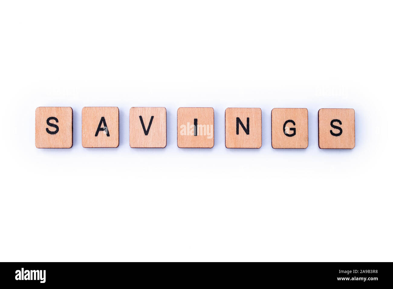 The word SAVINGS, spelt with wooden letter tiles Stock Photo - Alamy