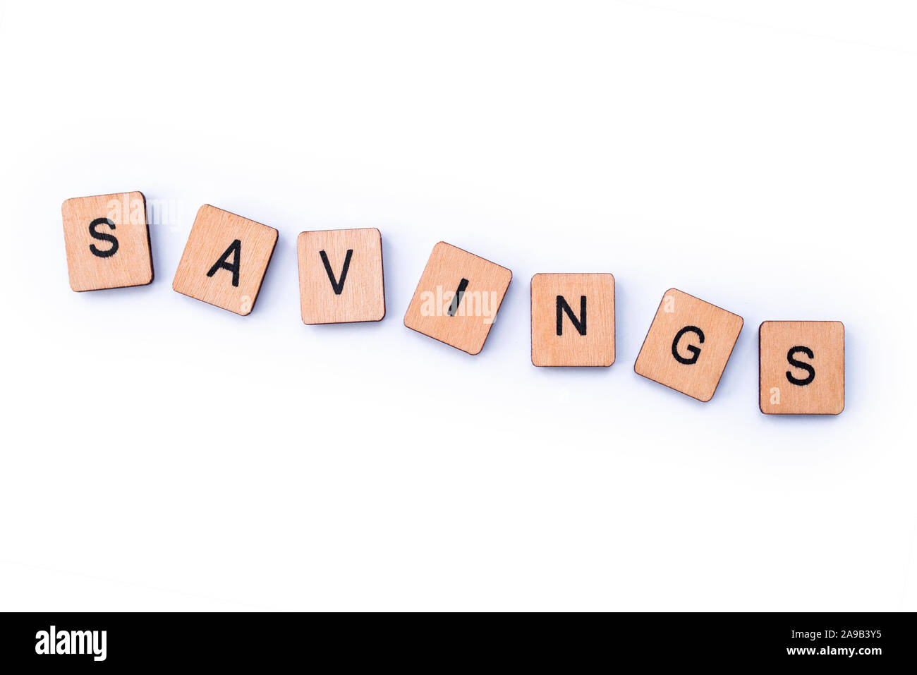 The word SAVINGS, spelt with wooden letter tiles Stock Photo - Alamy