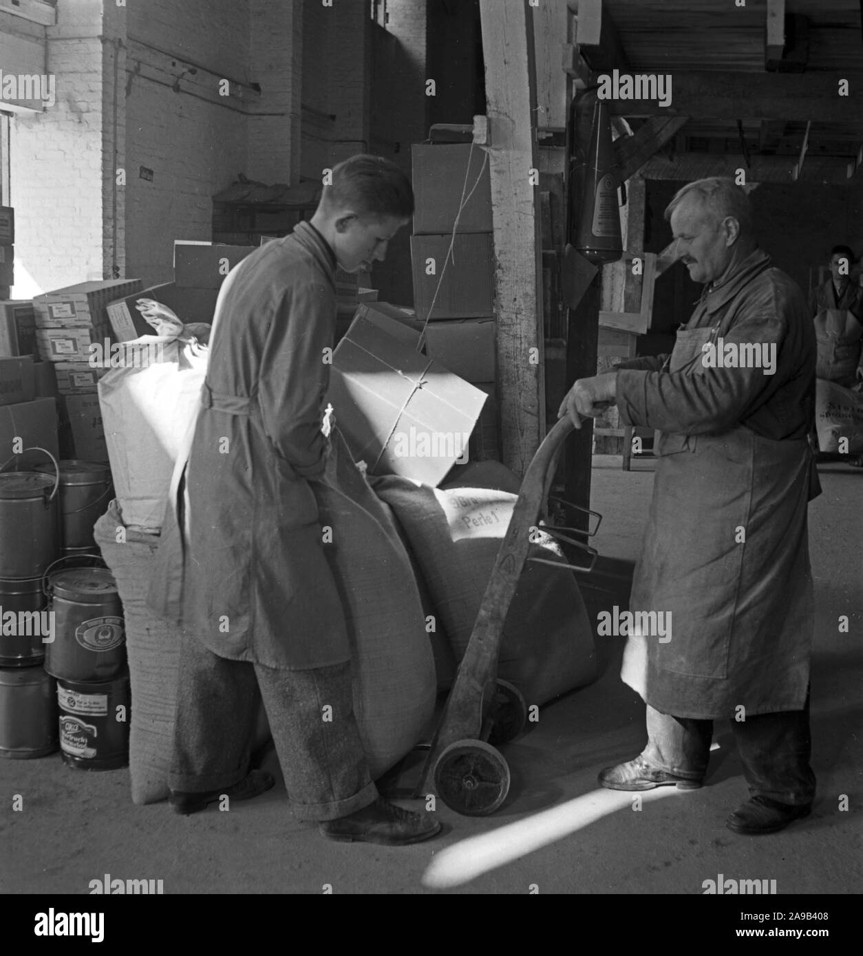 Apprentice and instructor packing and counting sacks at the warehouse ...