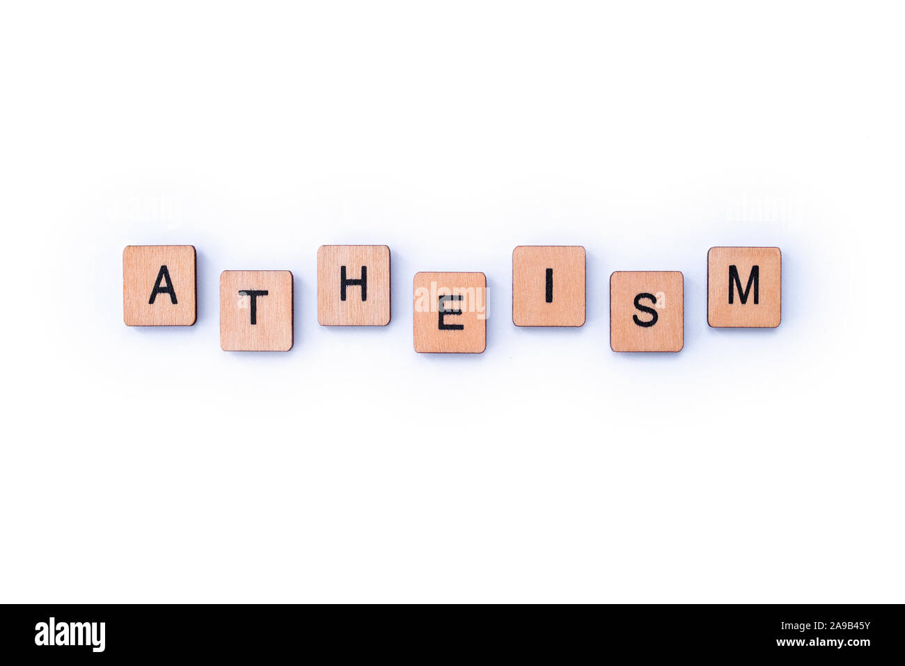 The word ATHEISM, spelt with wooden letter tiles Stock Photo - Alamy