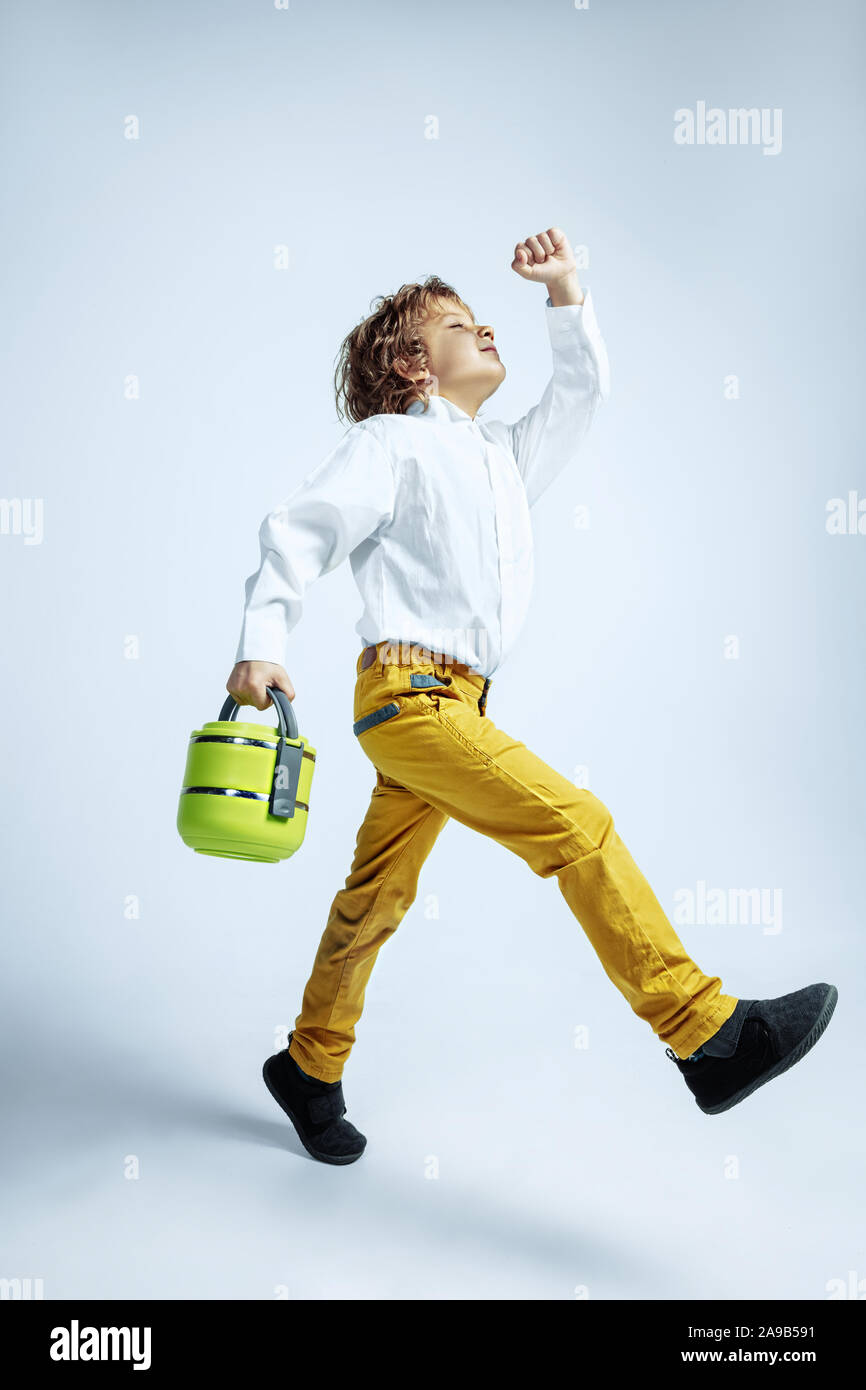 Pretty young boy in casual clothes on white studio background ...