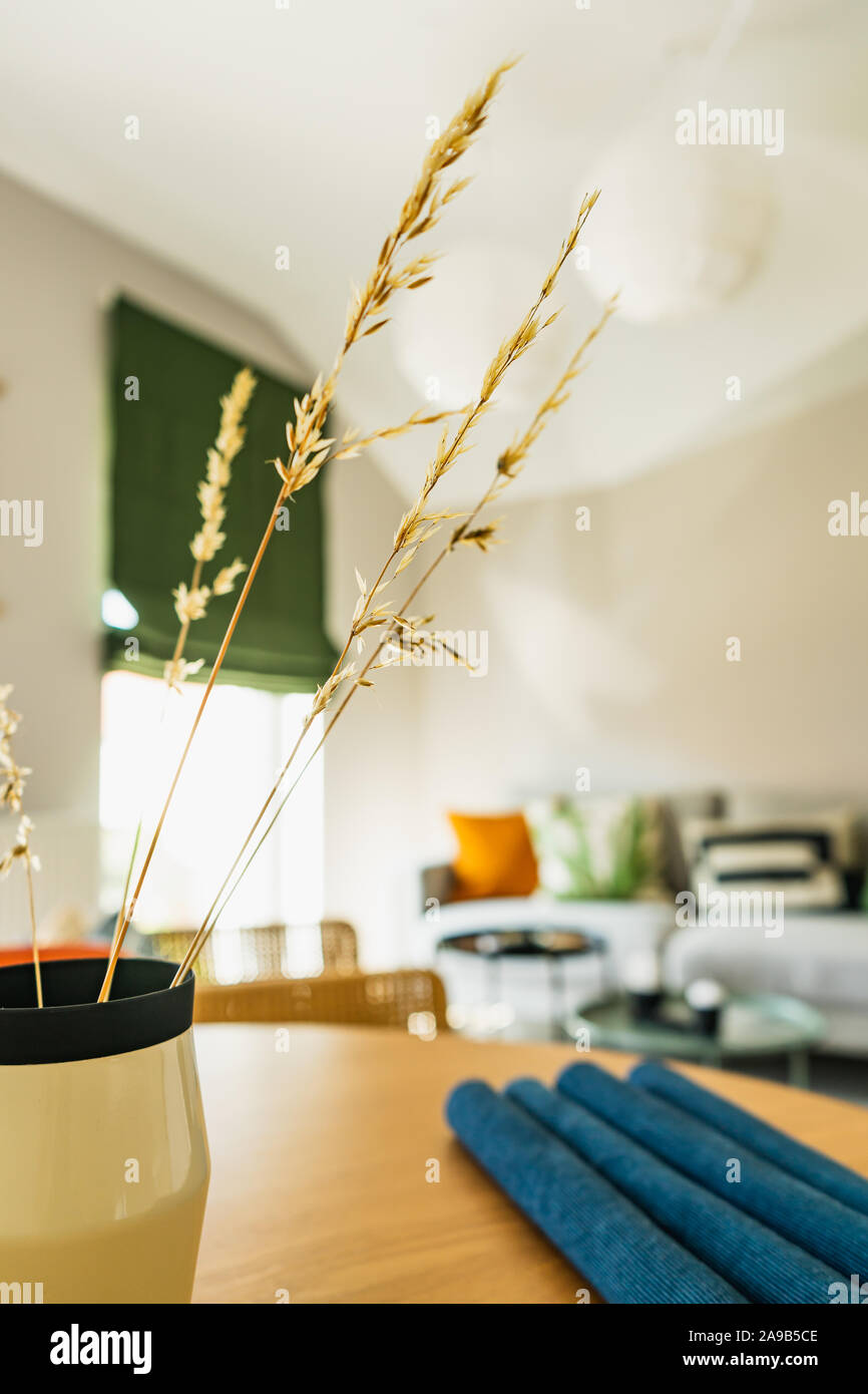 Modern,colorful, chic living room interior, close-up on vase with wheat ...