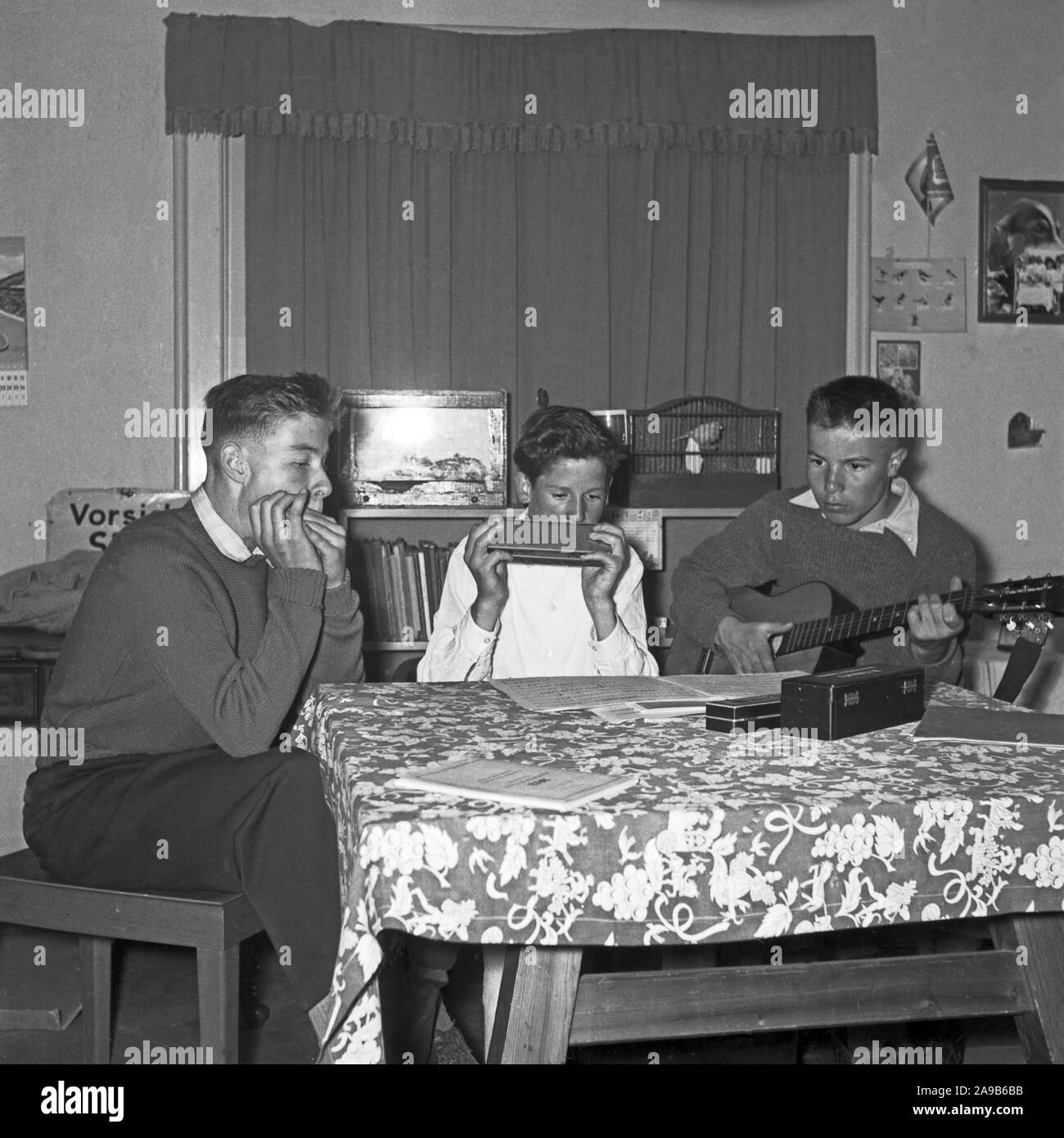 Three boys with harmonica and gutar playing their favourite songs ...