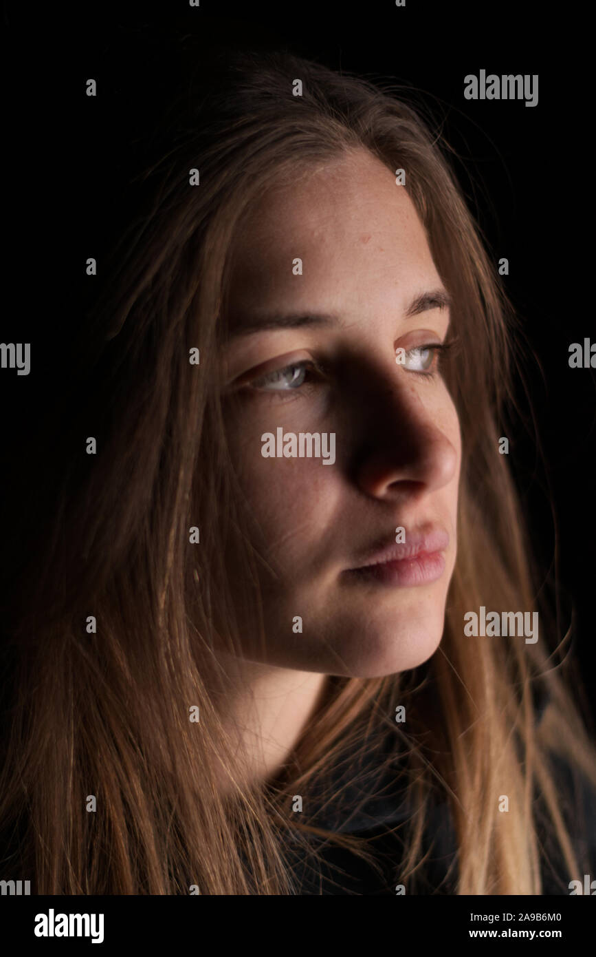 Portrait of a natural and fresh young woman with long hair. She has a ...