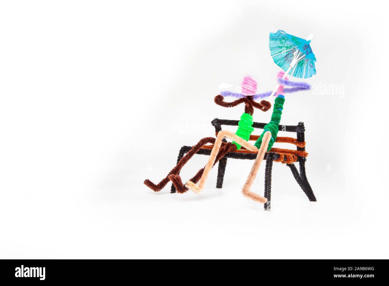 Pipe cleaner figures sitting on a pipe clearn bench Stock Photo - Alamy