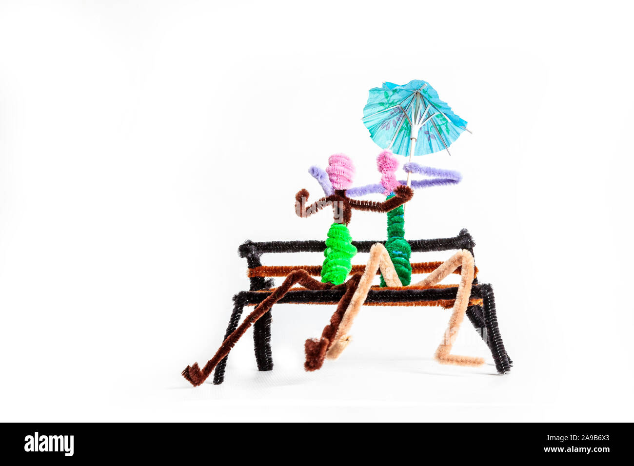 Pipe cleaner figures sitting on a pipe clearn bench Stock Photo - Alamy