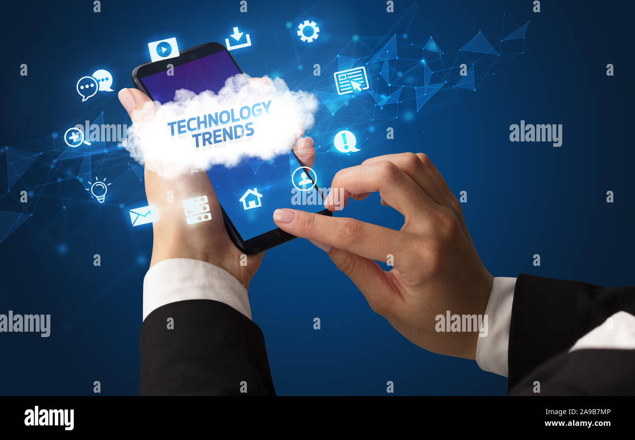 Female hand holding smartphone with TECHNOLOGY TRENDS inscription ...