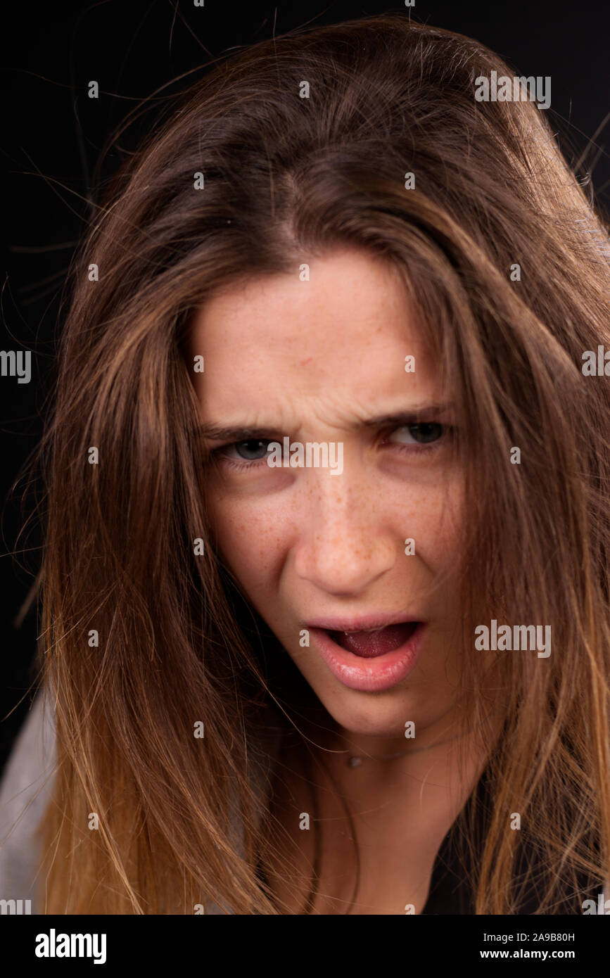 Portrait of a natural and fresh young woman with long hair. She has an ...