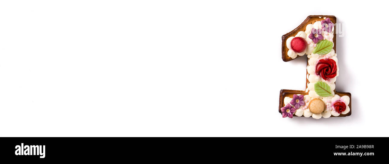 Number one cake decorated with flowers and macarons isolated on white ...