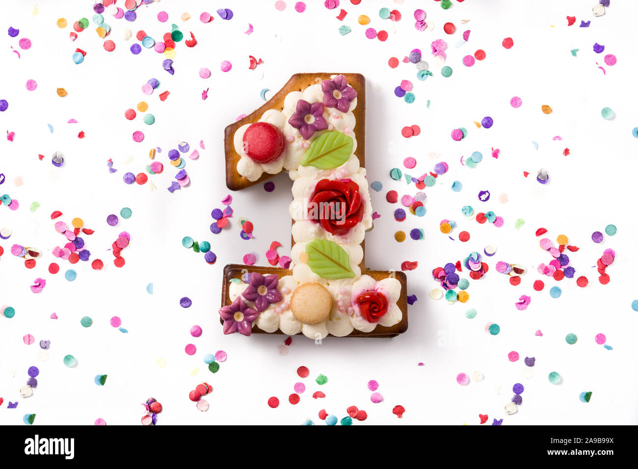 Number one cake decorated with flowers macarons and confetti isolated ...