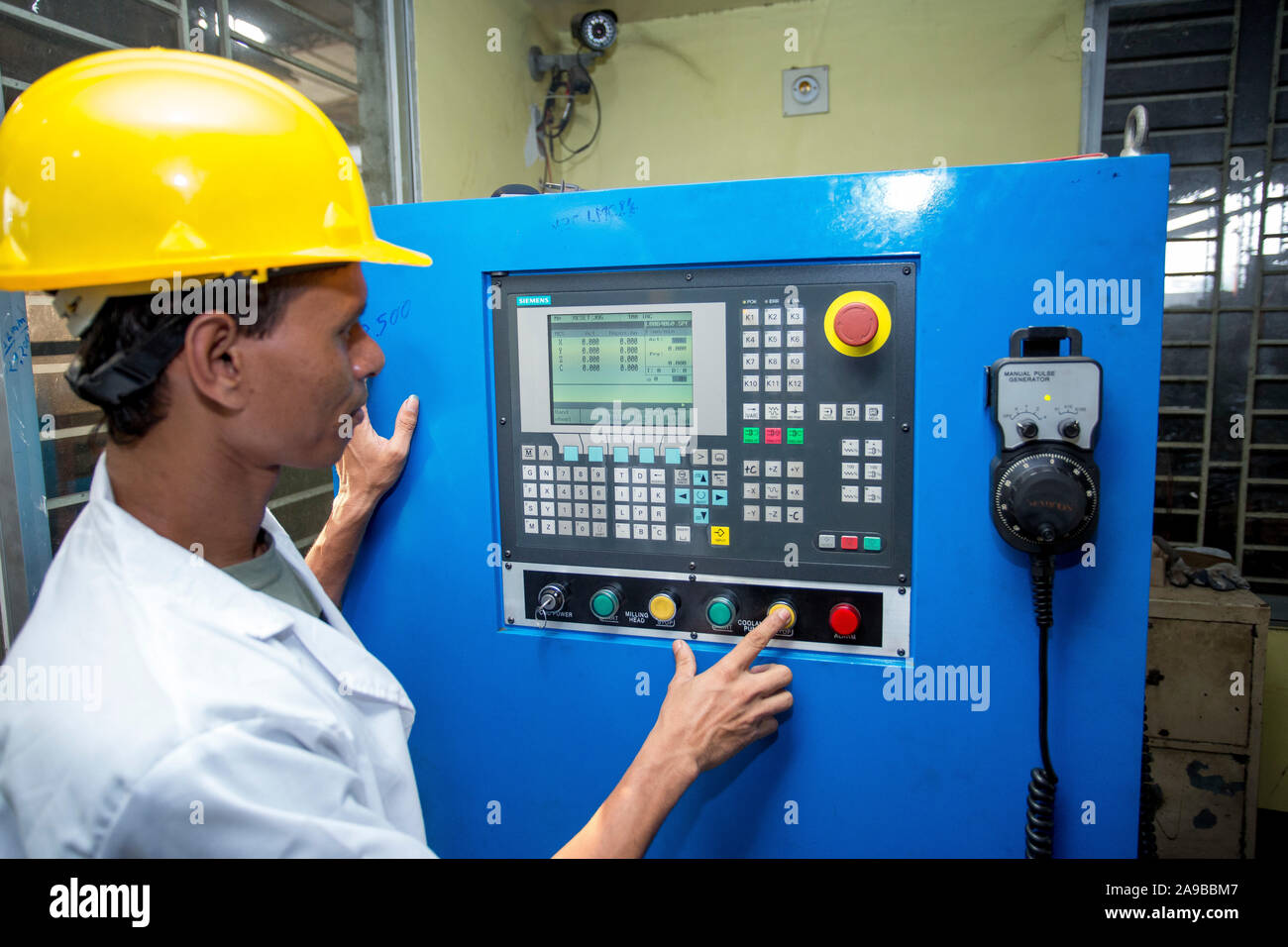 Bangladesh – May 20, 2015: A factory lab operator using Steel rod ...