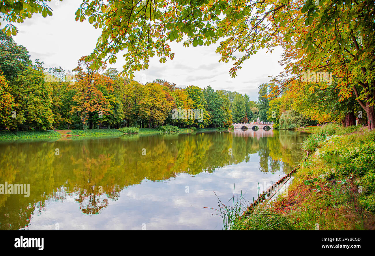 Bridge in the park on the lake. Royal Palace on the Water in Lazienki ...