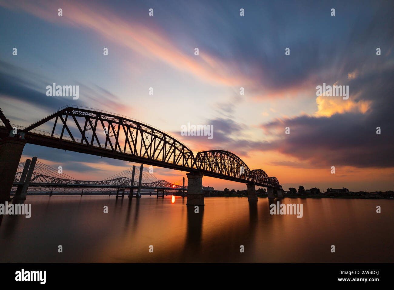 A long exposure sunset of the Big Four Bridge, which is a walking ...