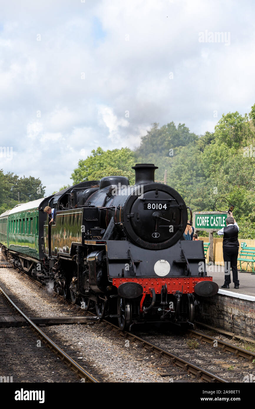 BR Standard class 4 tank engine 80104 steam train arriving Corfe castle ...