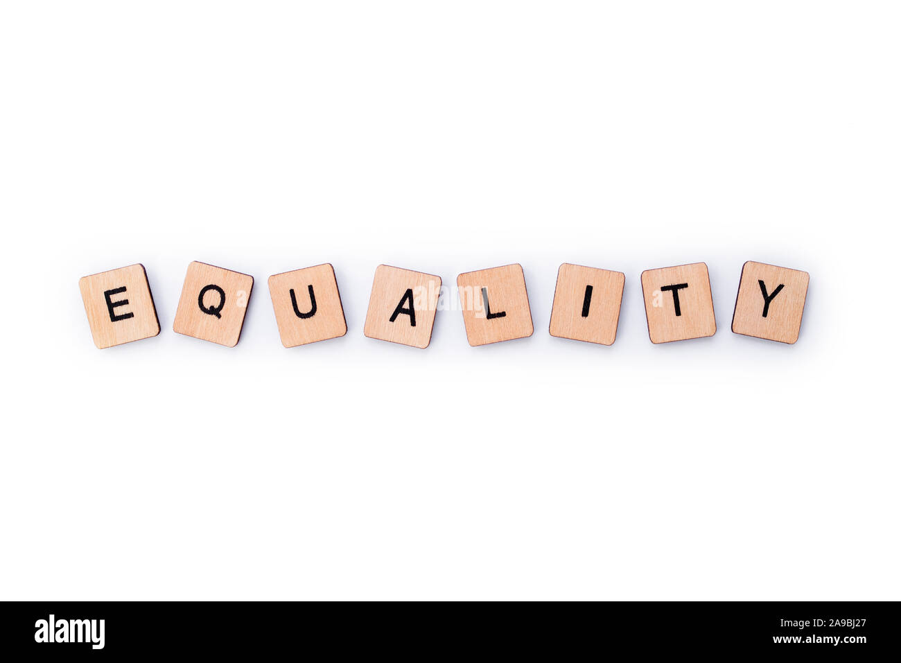 The word EQUALITY, spelt with wooden letter tiles over a white ...