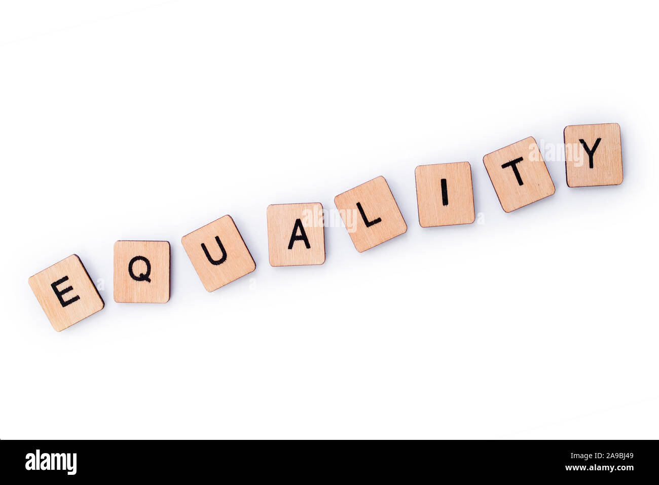 The word EQUALITY, spelt with wooden letter tiles over a white ...